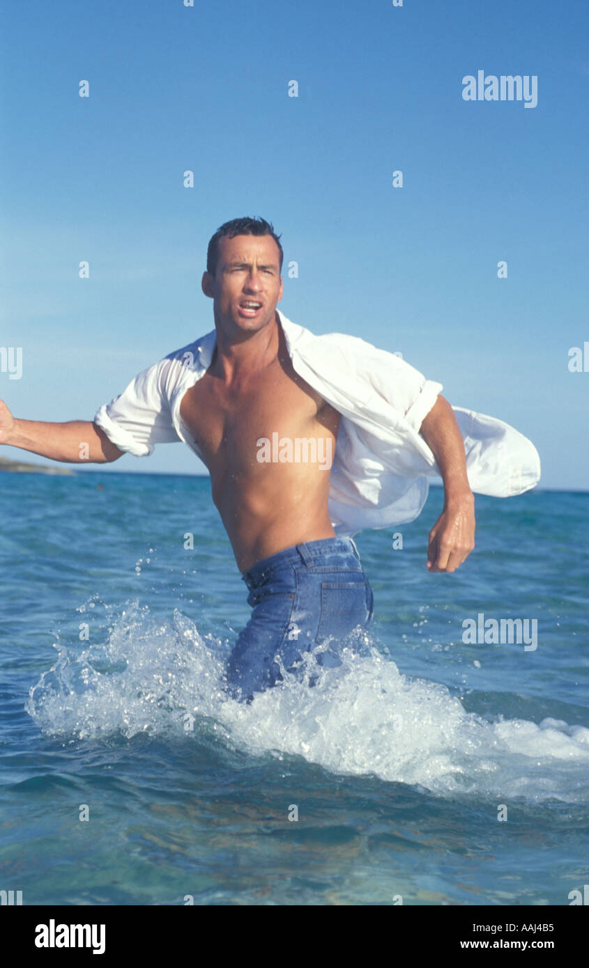 man running through water at beach Stock Photo - Alamy