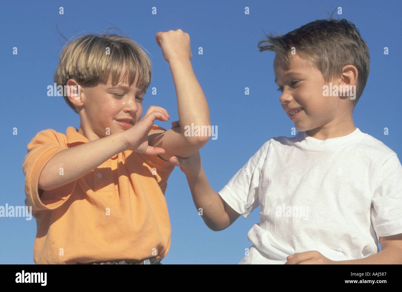 two boys showing muscles Stock Photo - Alamy