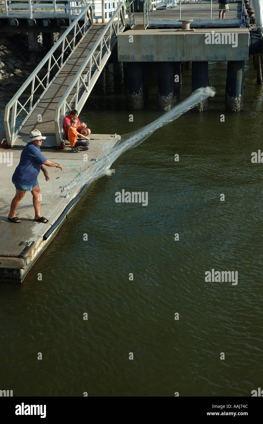 Retired man casts net to catch bait for fishing trip Cooktown ...