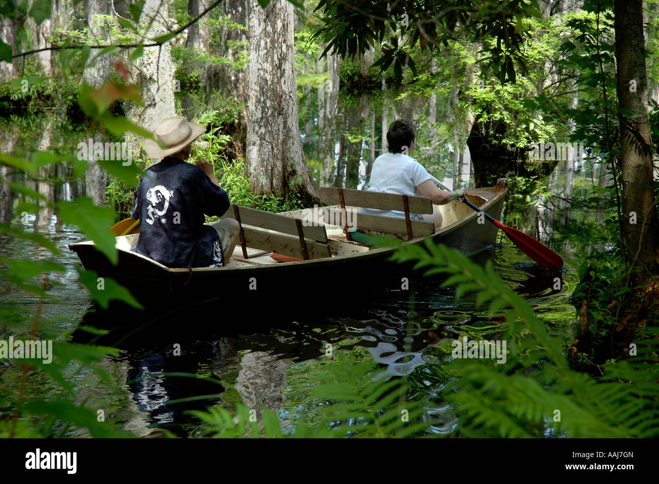 couple touring Southern swamp in boat Stock Photo - Alamy