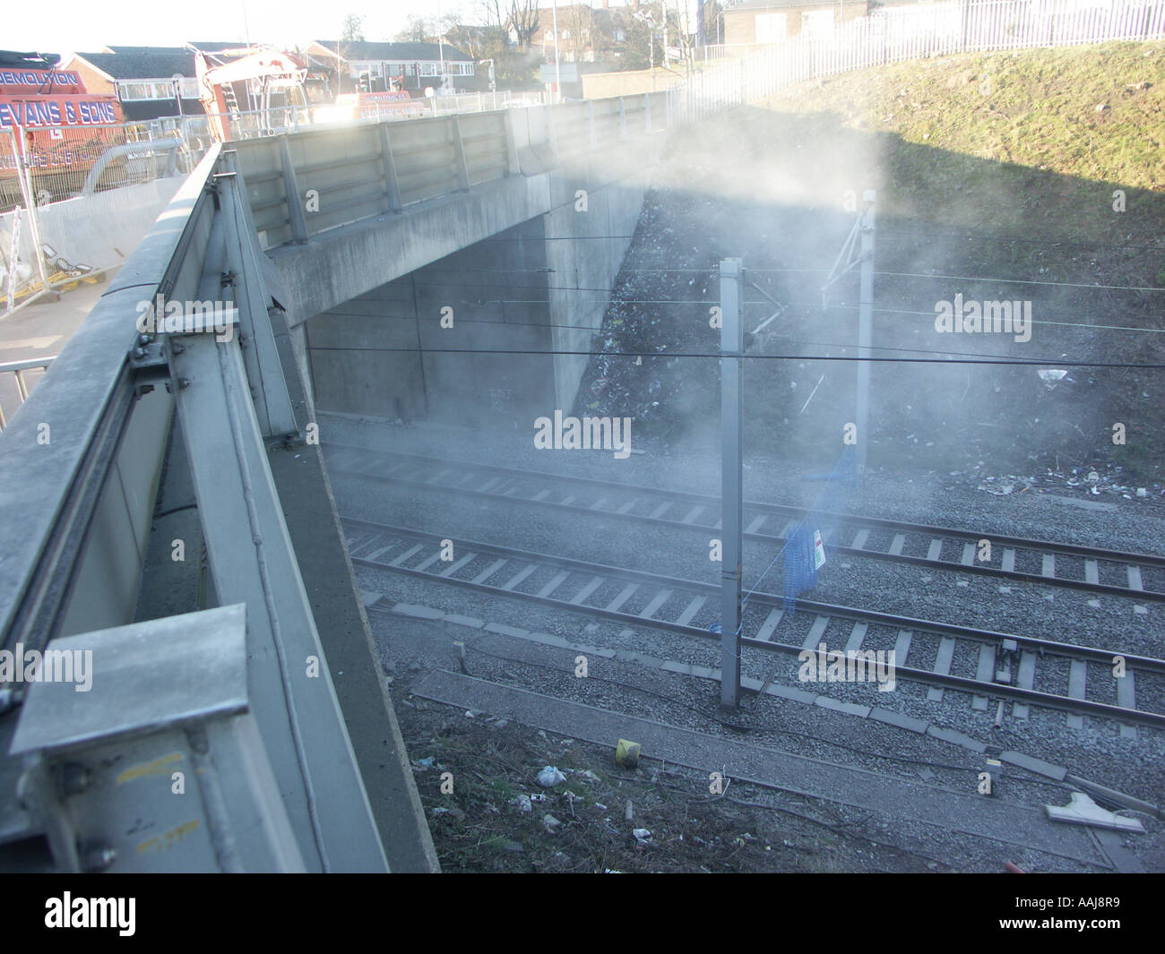 Clouds of concrete dust drifting over railway track during major works ...