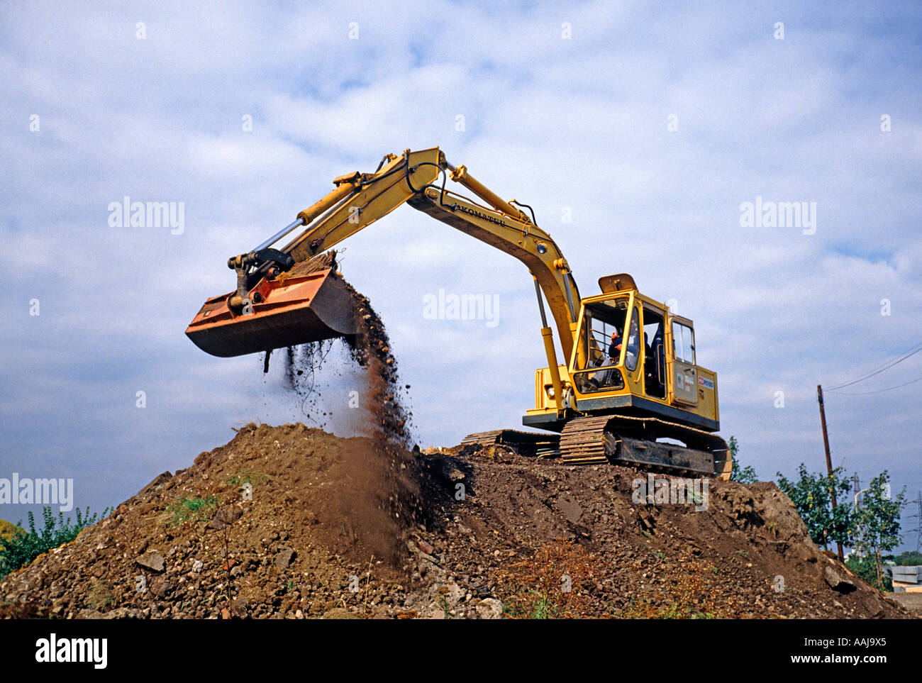 Digger on mound Stock Photo - Alamy