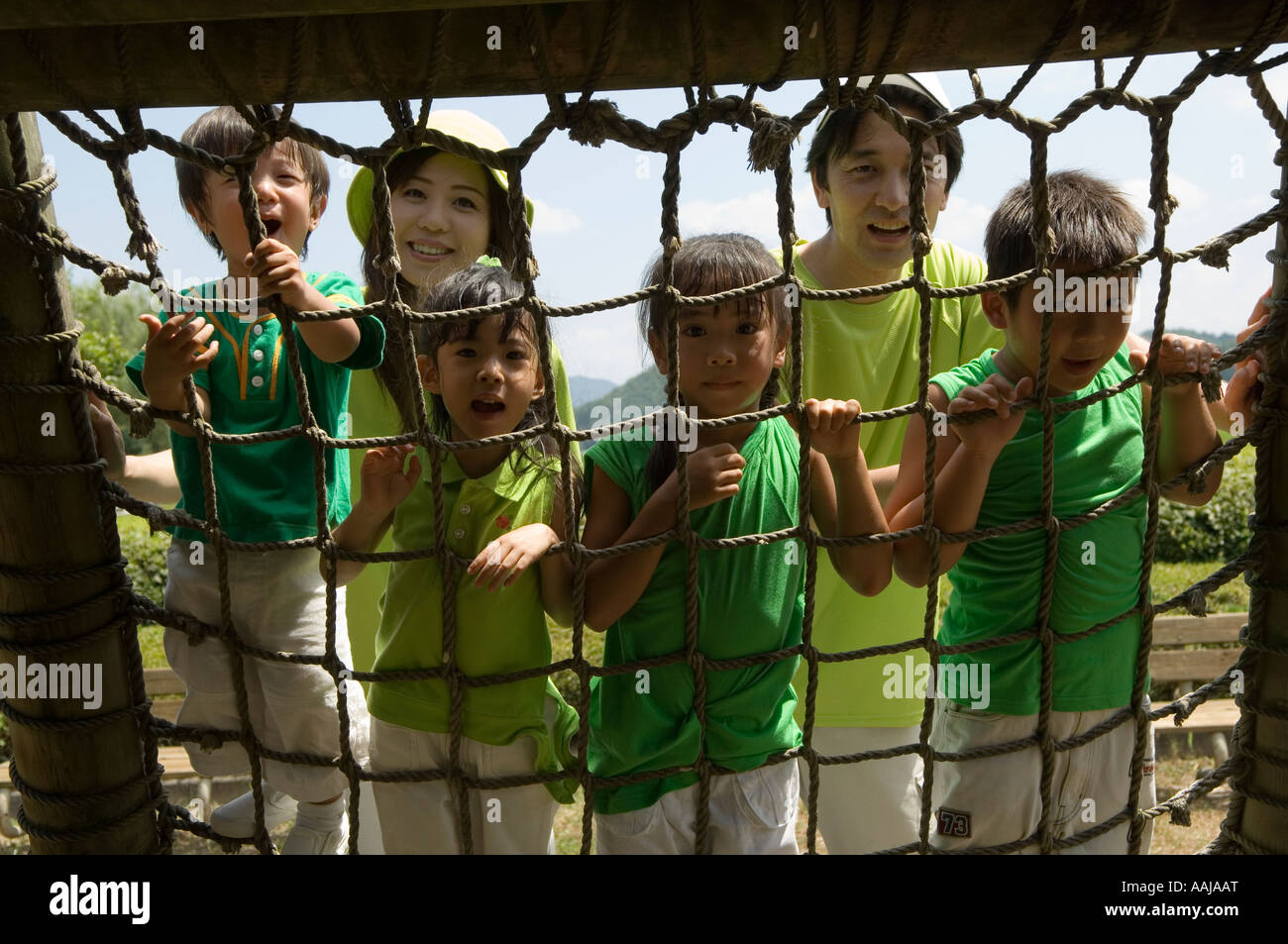 Family playing in playground Stock Photo - Alamy