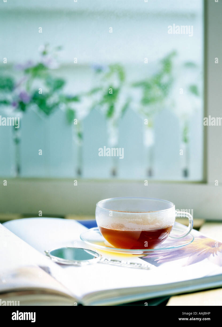 Black tea and book Stock Photo - Alamy