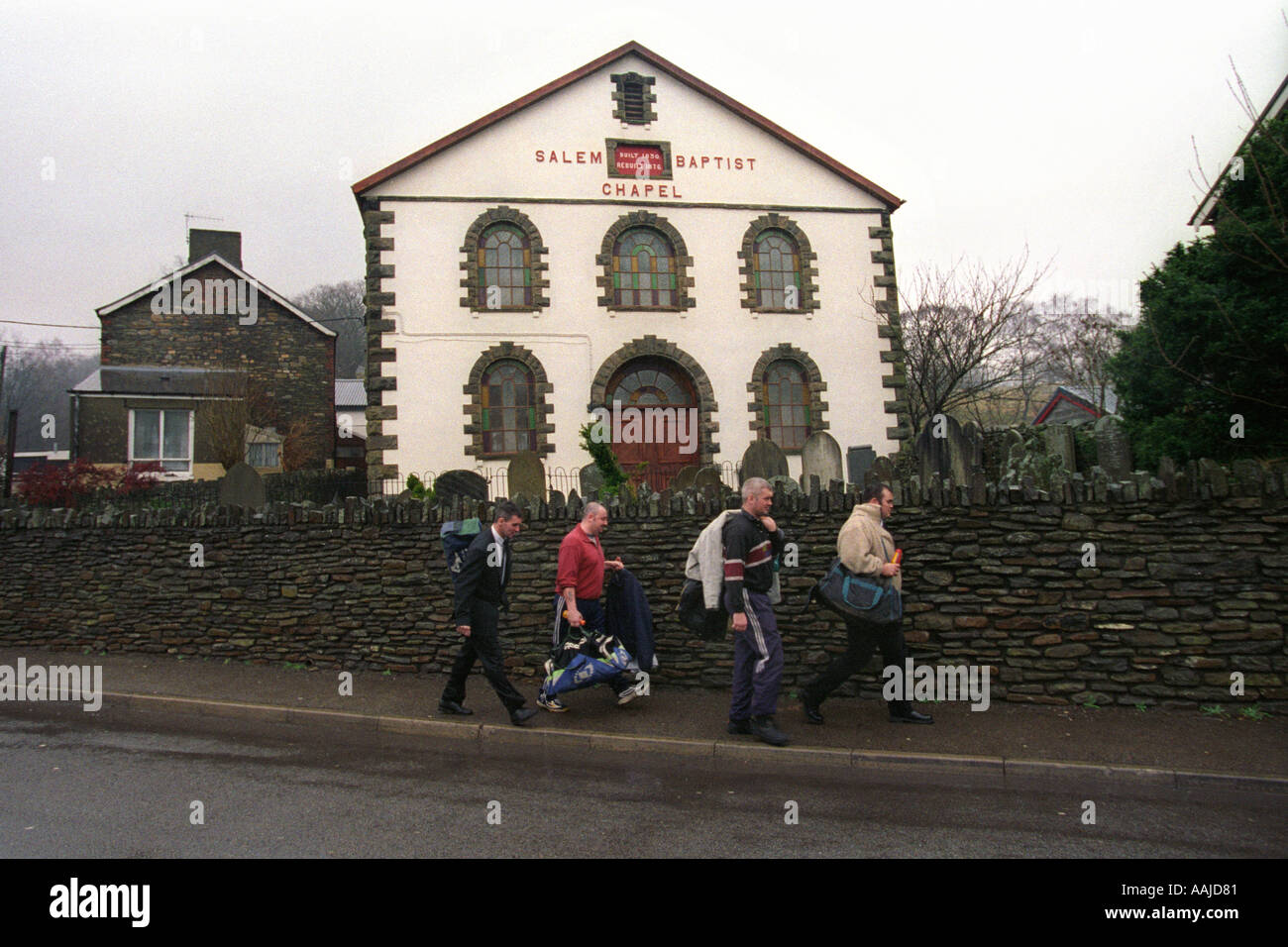 Bedlinog RFC rugby players walk past the village chapel on the way to a ...