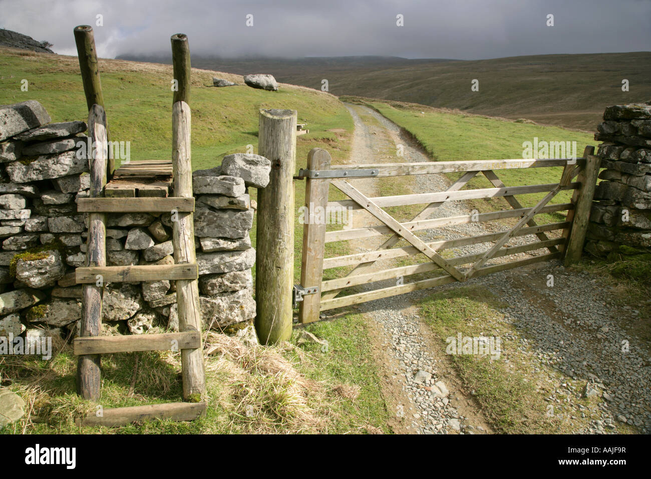 Wooden ladder stile and gate on Fell Lane bridleway approaching ...