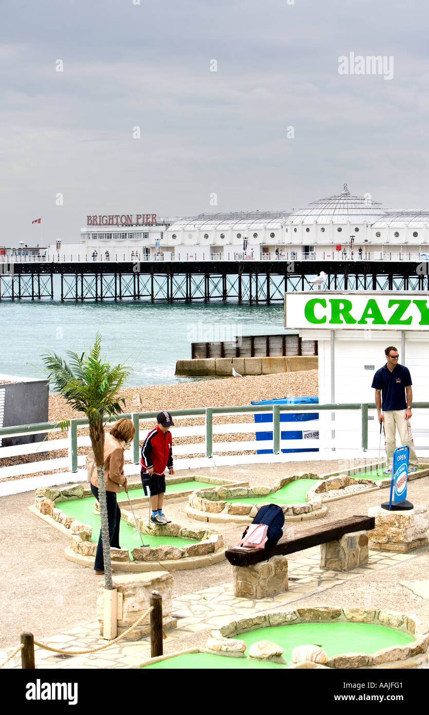Playing crazy golf with Brighton pier in background Brighton England ...