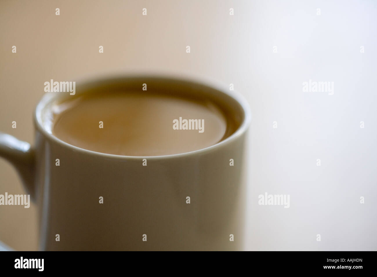 A white mug of white tea on a wood effect kitchen worktop Stock Photo ...