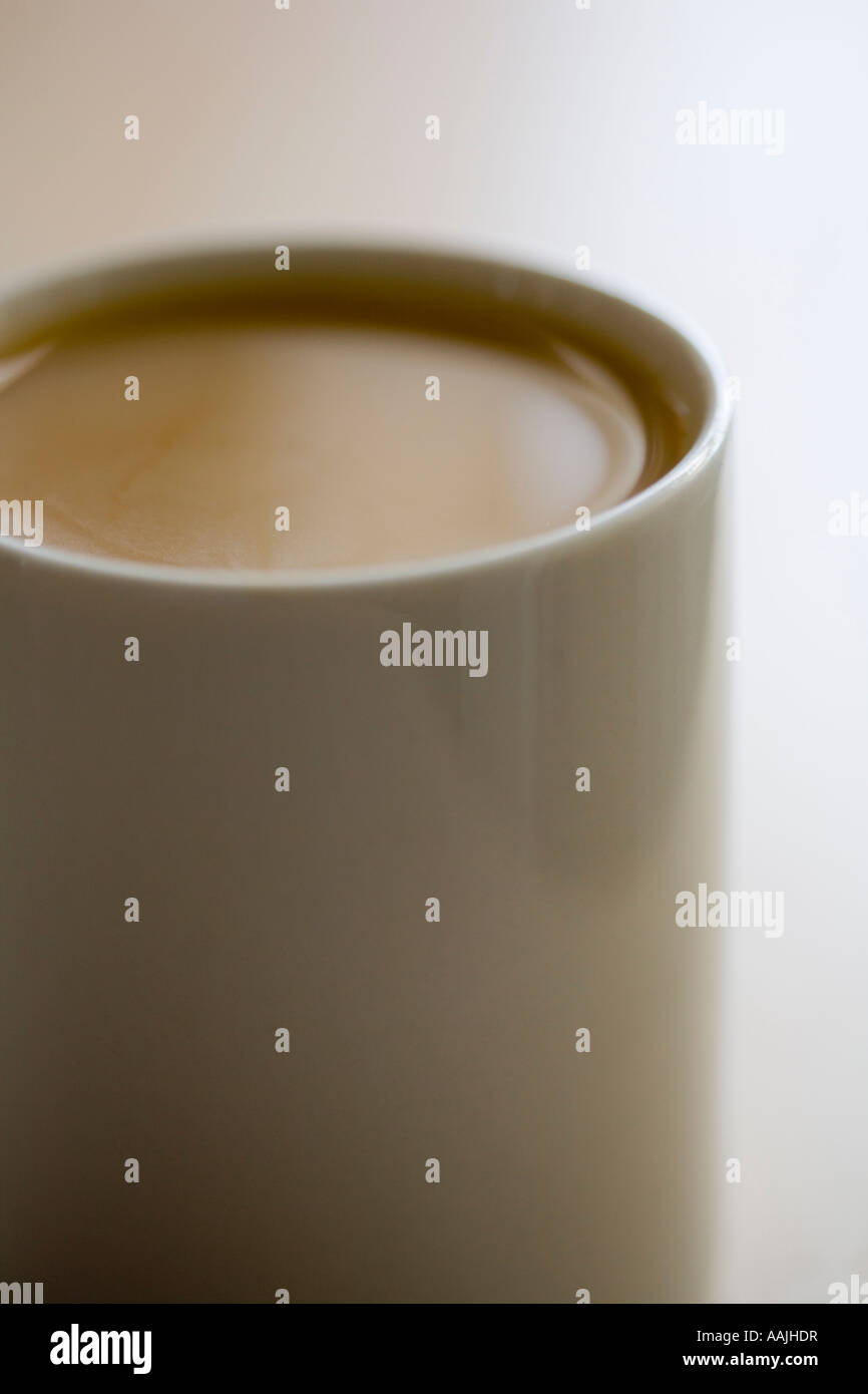 A white mug of white tea on a wood effect kitchen worktop Stock Photo ...