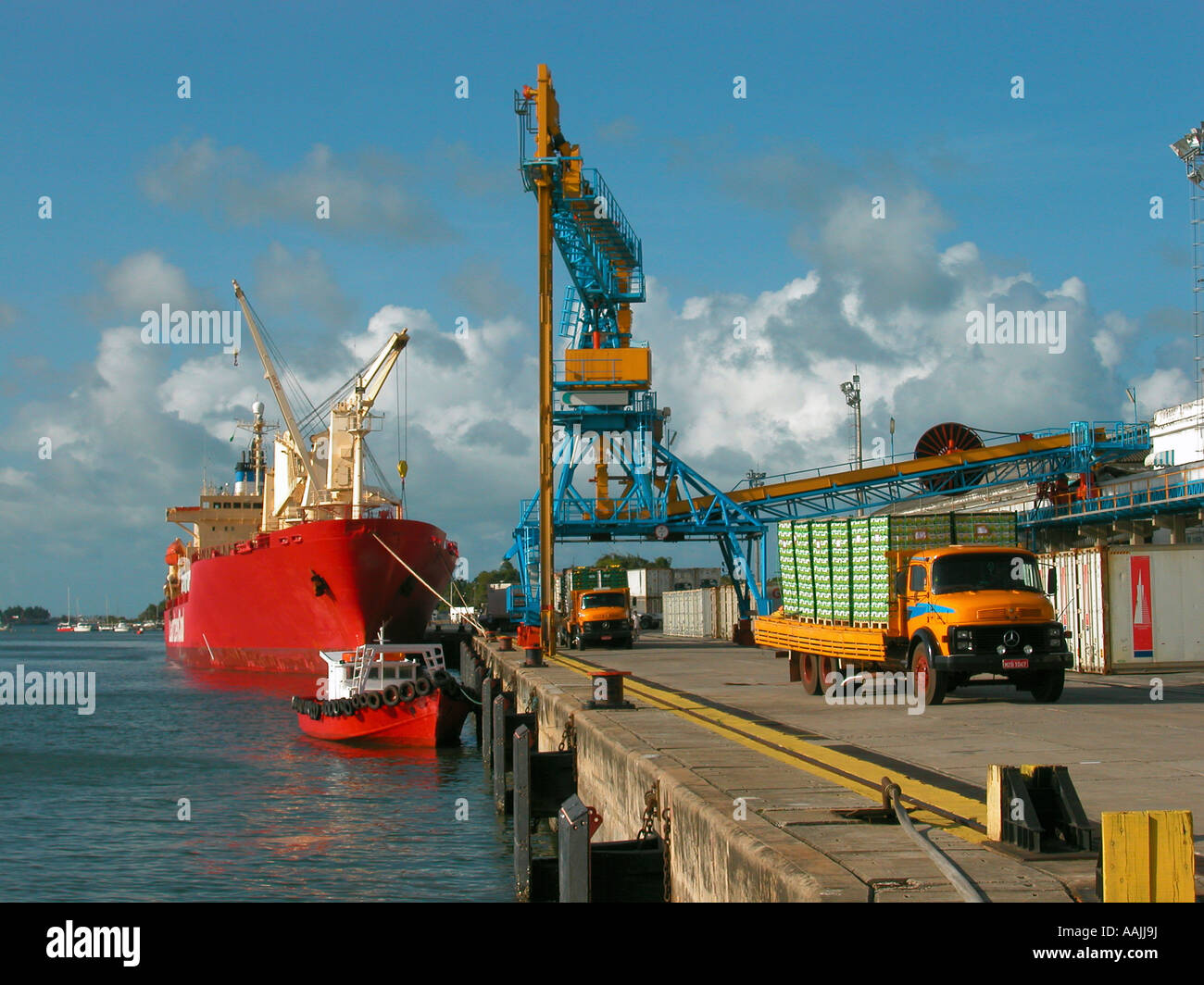 Cranes Lowering Cargo Containers From a Cargo Ship Moored at Harbour ...