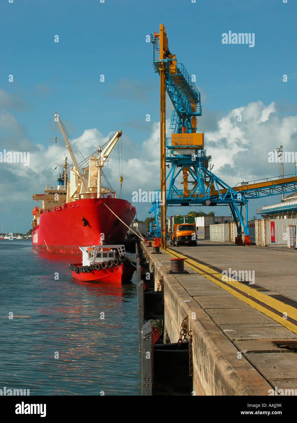 Cranes Lowering Cargo Containers From a Cargo Ship Moored at Harbour ...