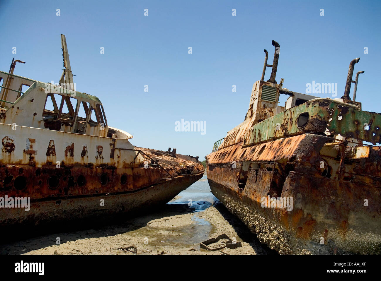 Two rusted ships on a beach Stock Photo - Alamy