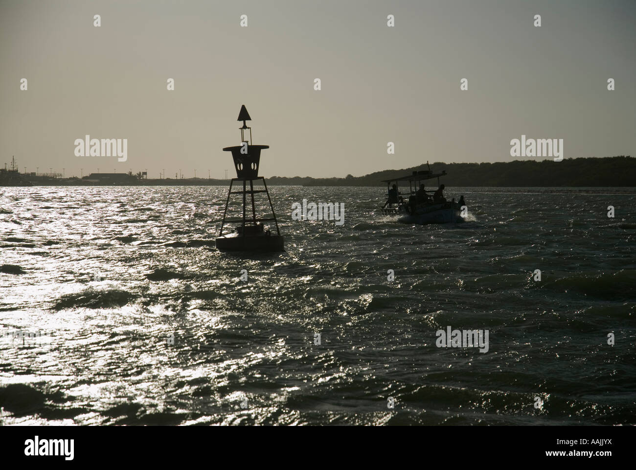 navigation mark and boat in the sea, sunset back light Stock Photo - Alamy