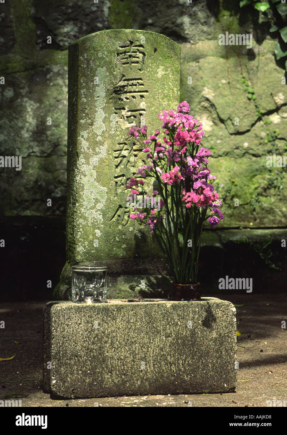 Gravestone and flowers in Kyushu Japan Stock Photo - Alamy