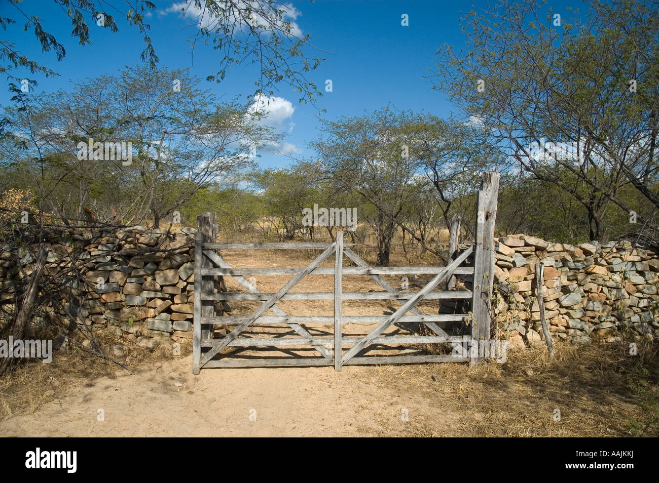 wooden gate and rock wall Stock Photo - Alamy