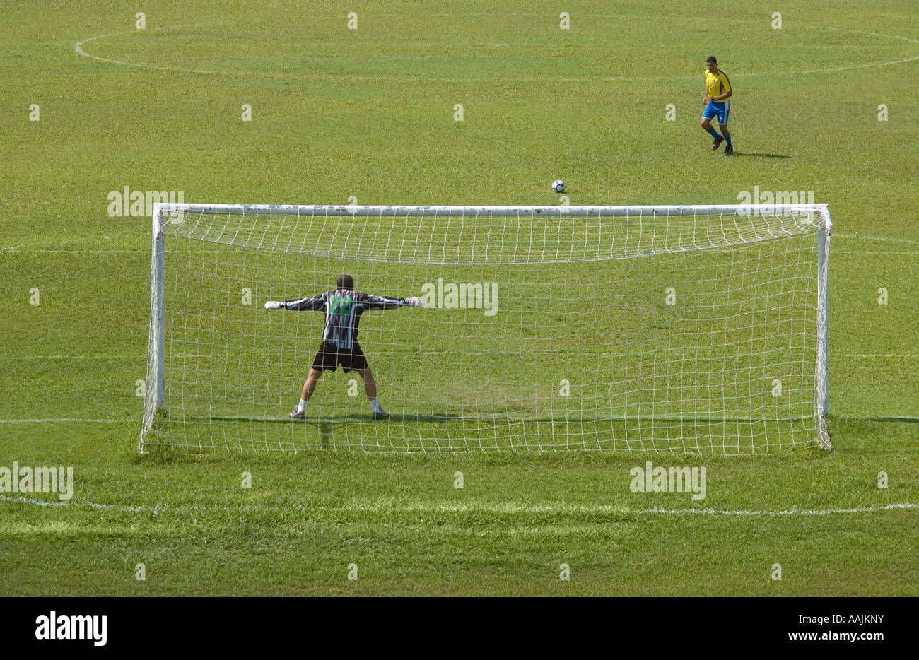Football goalkeeper defending penalty striker Stock Photo - Alamy