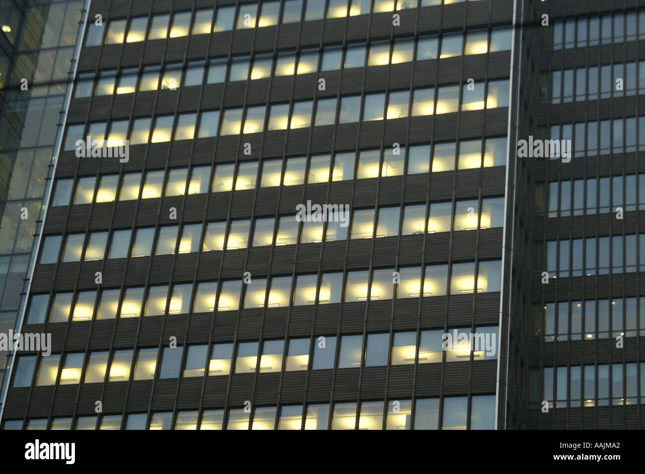 Business building in the early evening with many lights on Stock Photo ...