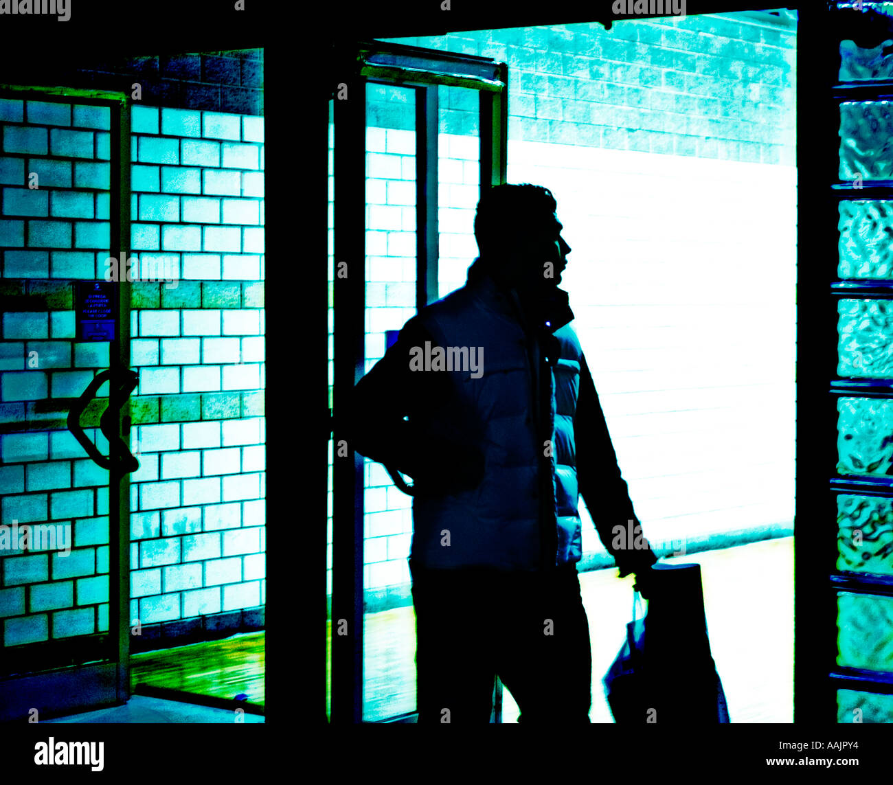 man walking out of door Stock Photo - Alamy