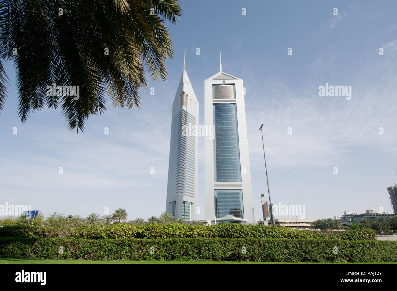 Emirates Towers with palm tree Stock Photo - Alamy