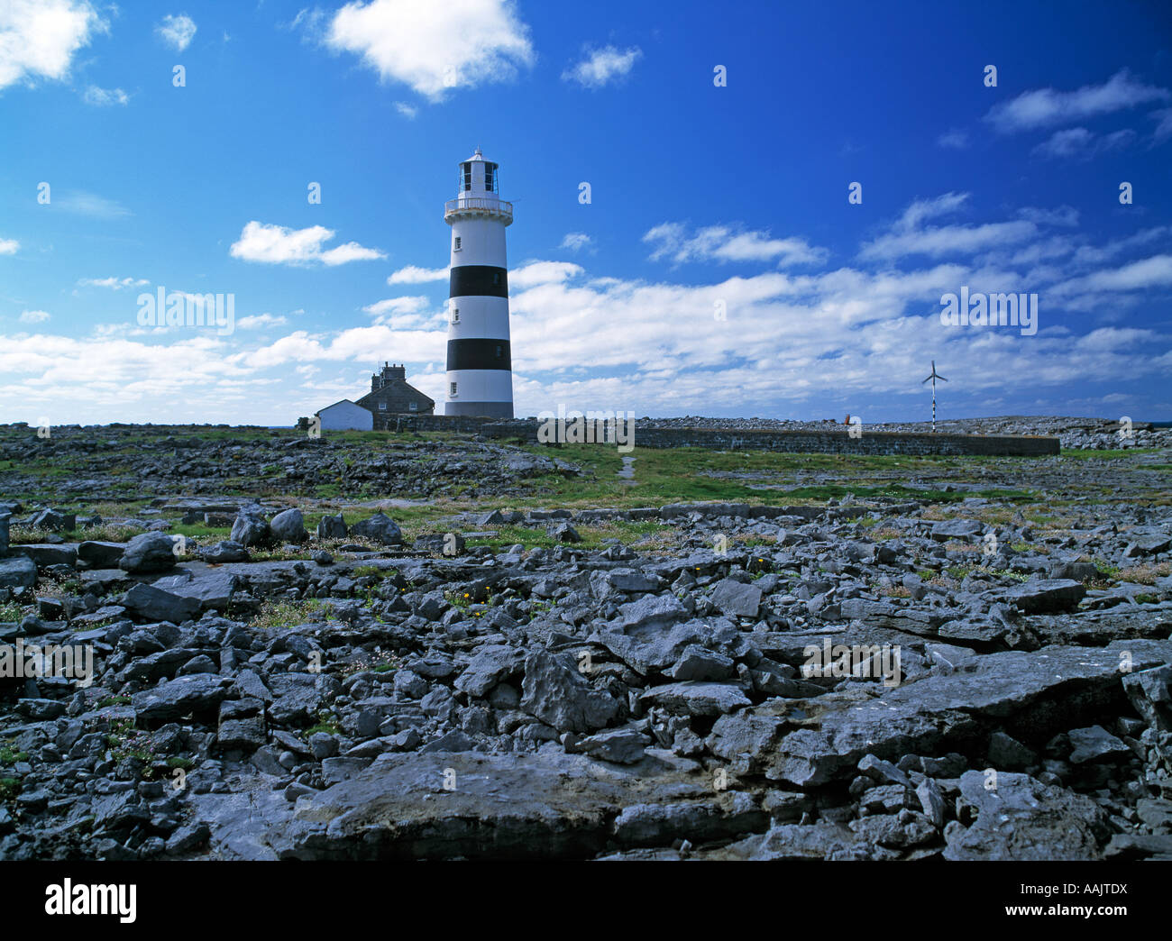 ireland, county galway, aran islands, lighthouse on a rocky outcrop on ...