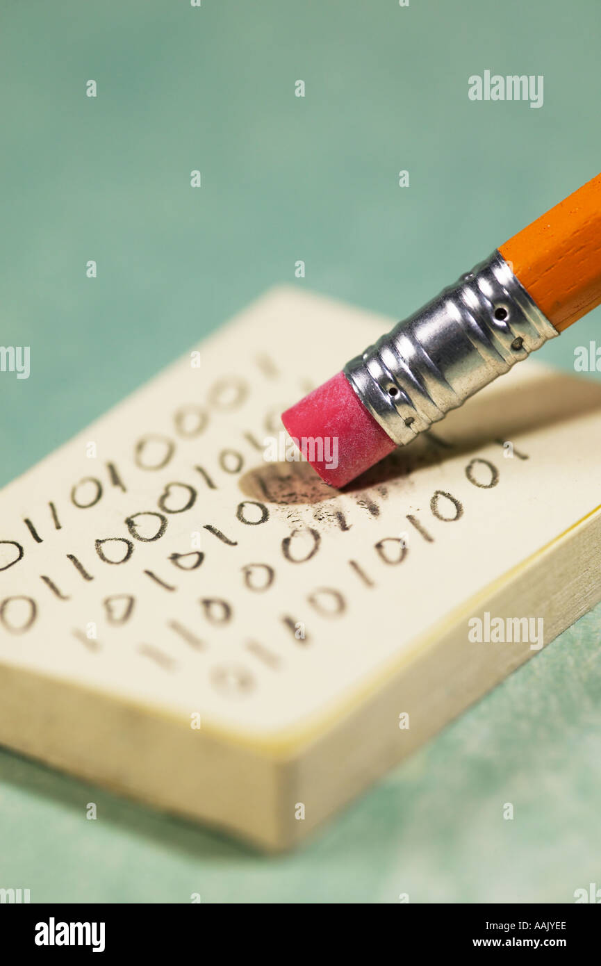 Pencil erasing binary code on yellow post it note Stock Photo - Alamy
