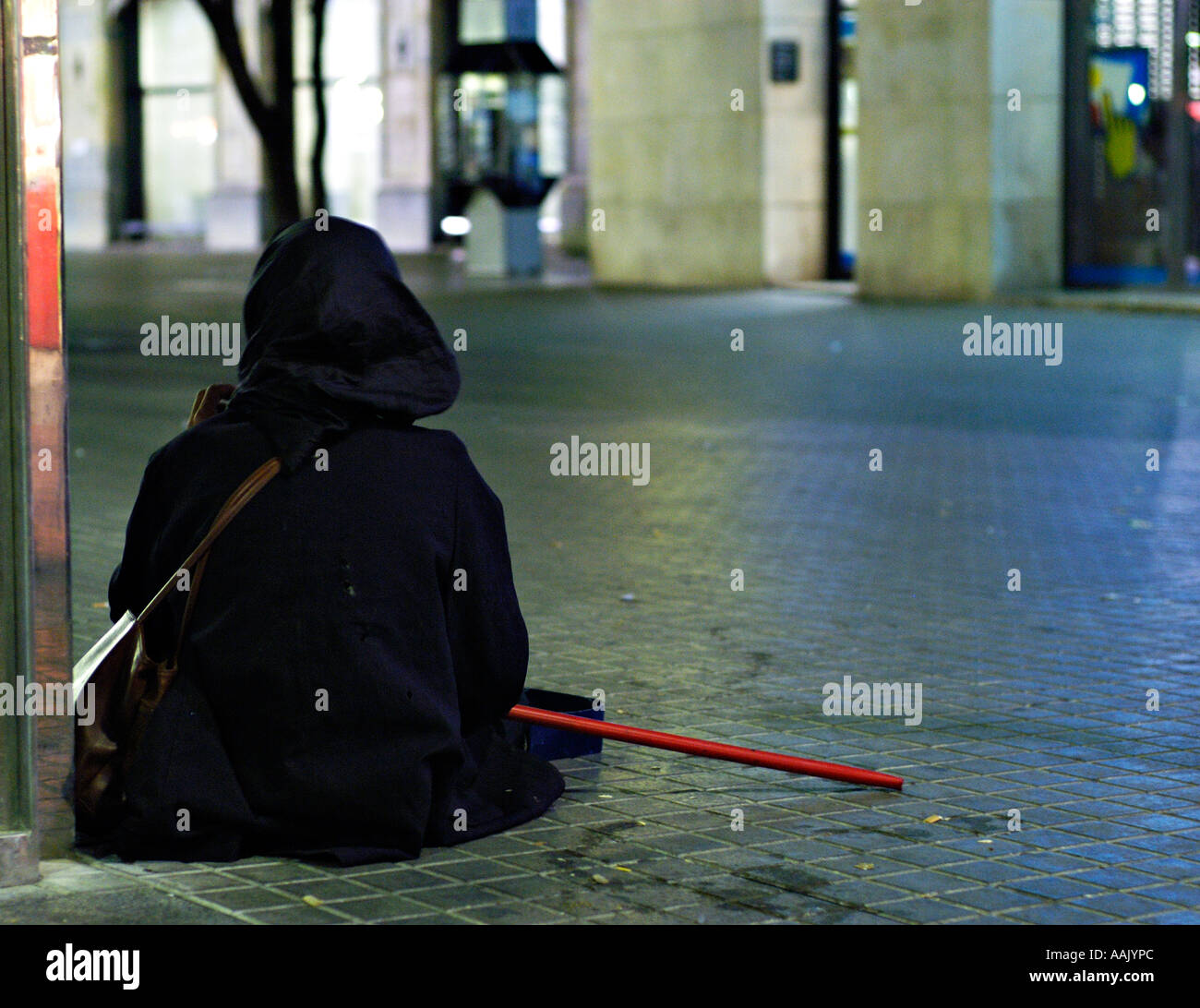 homeless in barcelona spain with red stick and black coat Stock Photo ...