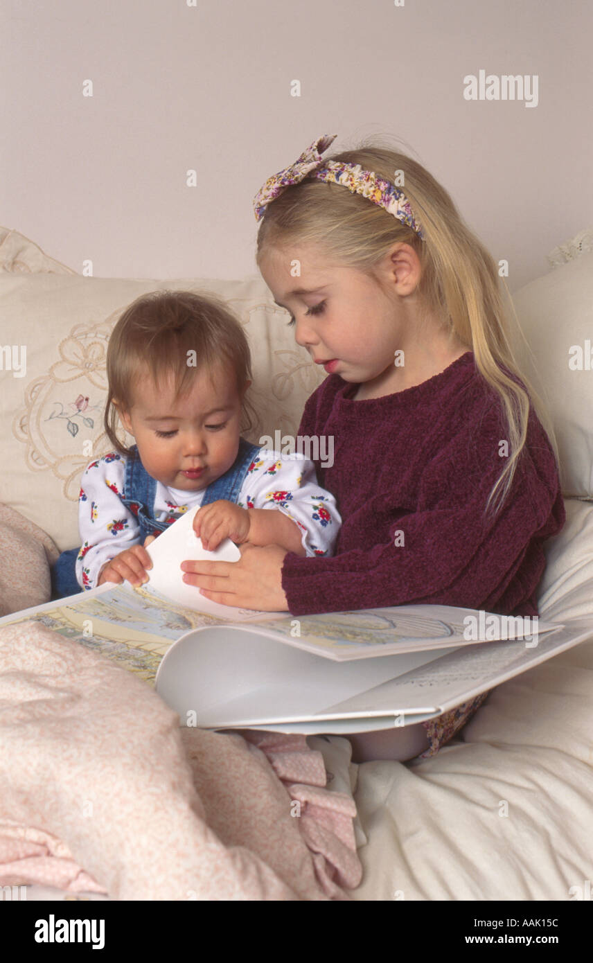 Big sister reading Stock Photo - Alamy