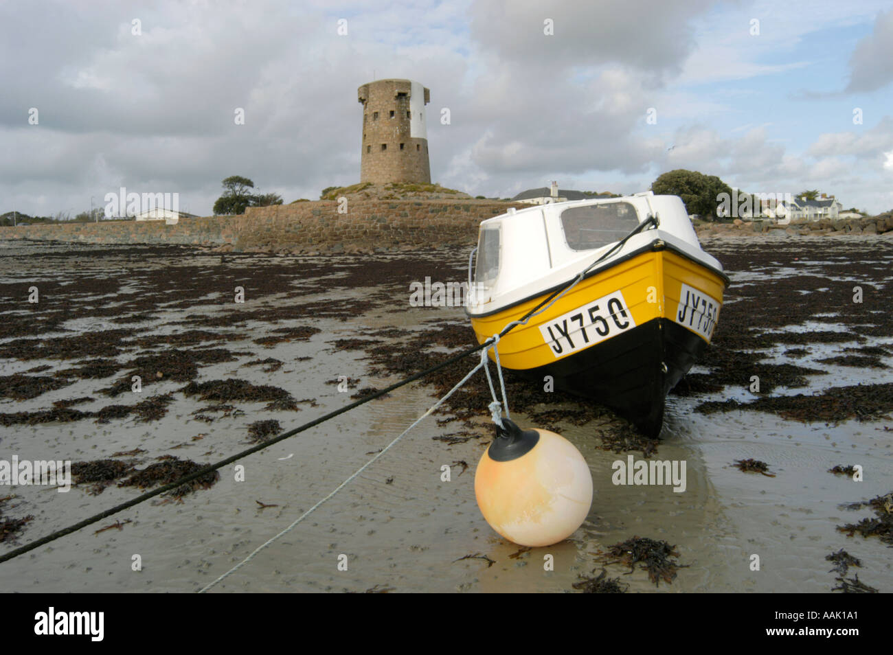 Beached boat on beach in front of WWII watchtower at St Clements bay in ...