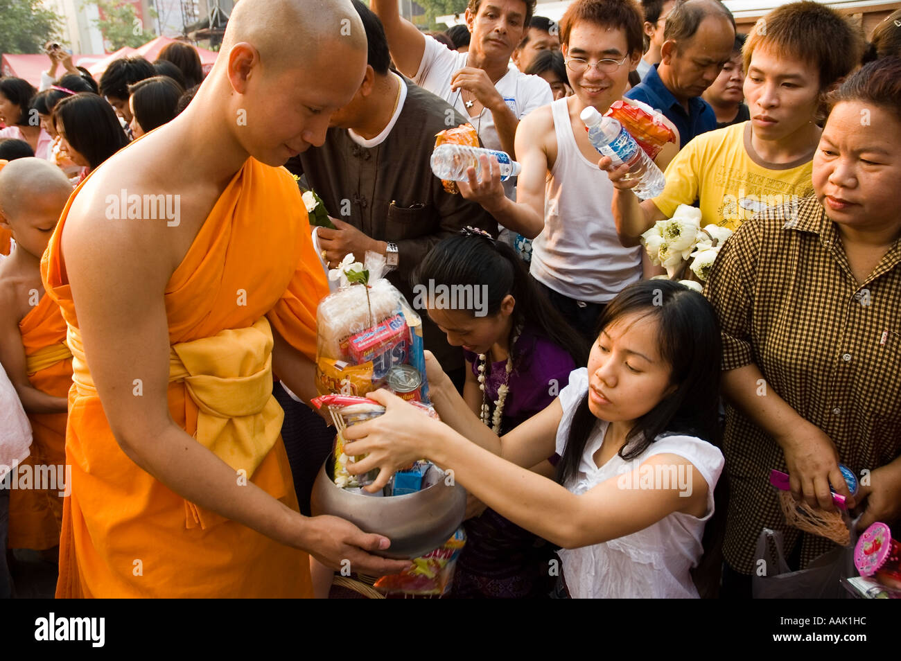 Buddhist monks participate in morning merit making ceremonies during ...