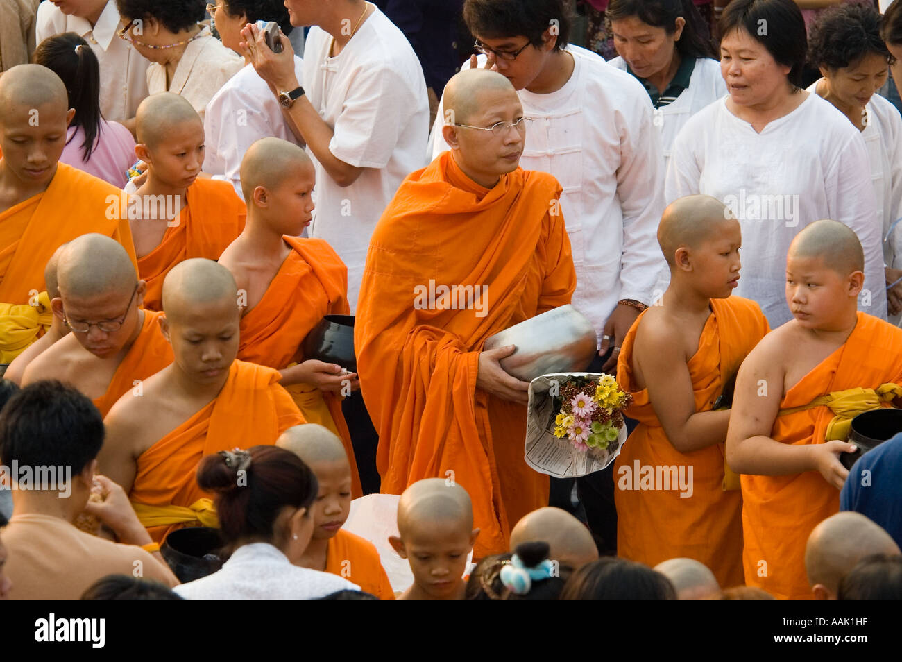 Buddhist monks participate in morning merit making ceremonies during ...