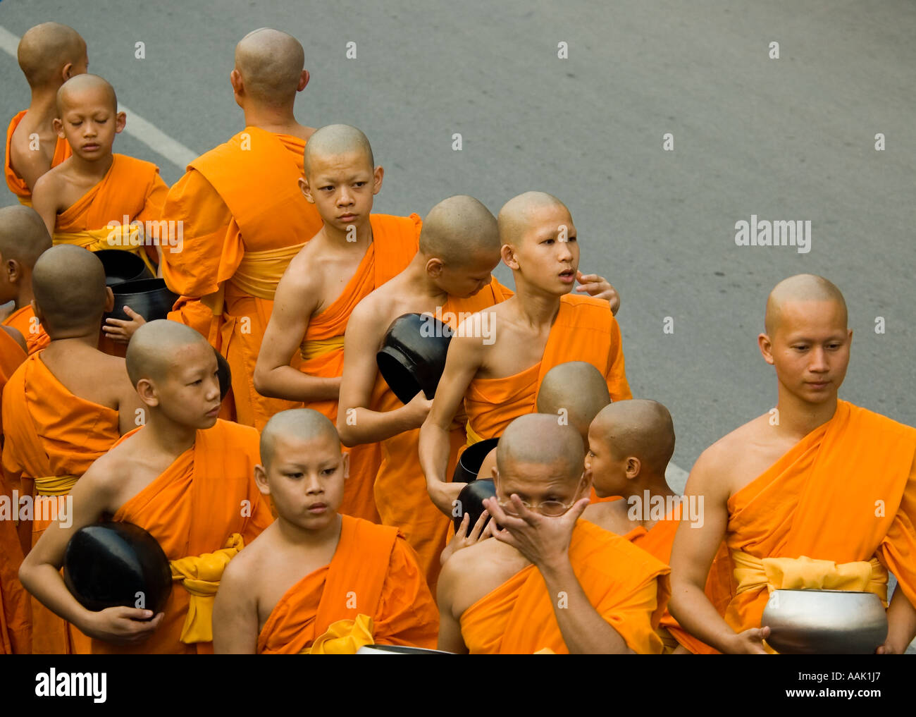 Buddhist monks participate in morning merit making ceremonies during ...