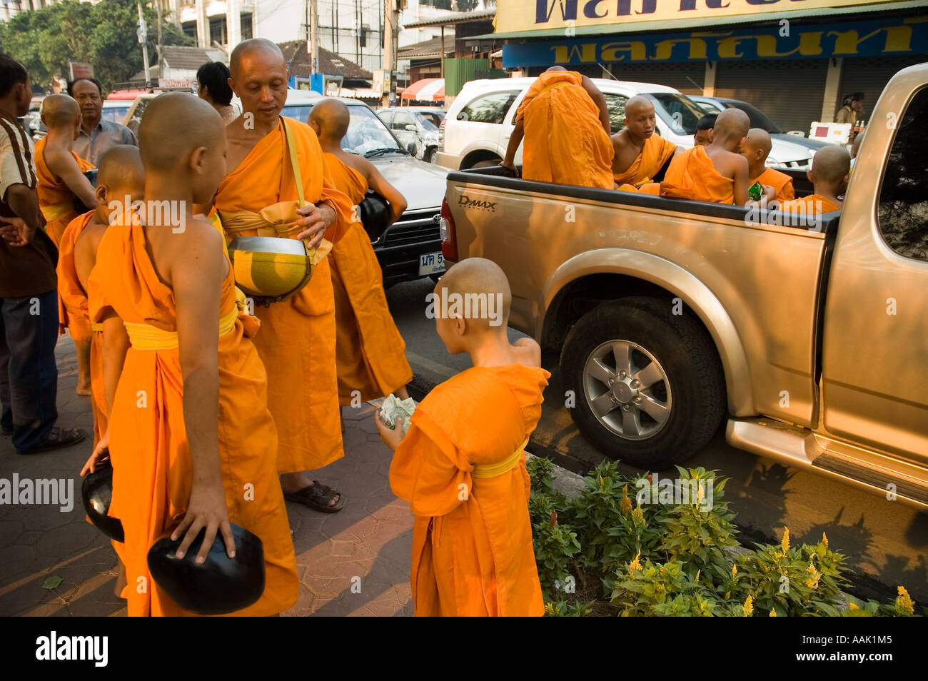 Buddhist monks participate in morning merit making ceremonies during ...