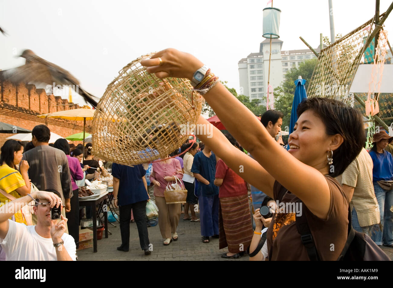 A woman releases birds from a cage to gain good luck in Chiang Mai ...
