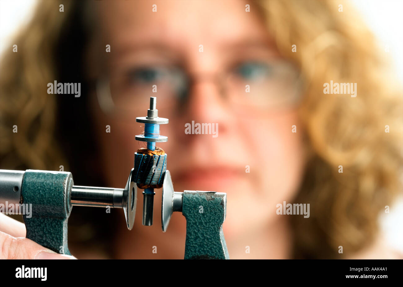 woman engineer holding microscope measuring component Stock Photo - Alamy