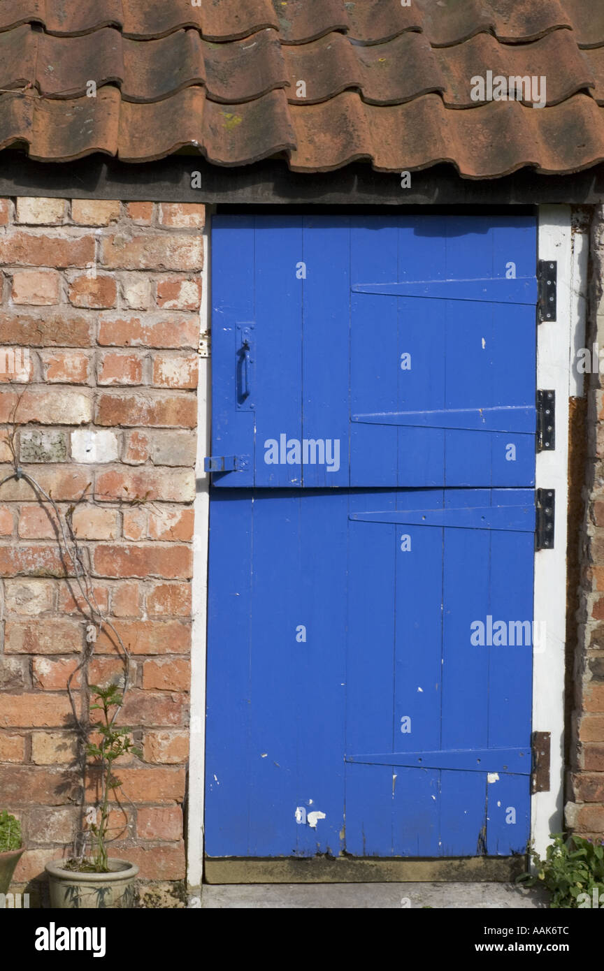 An old blue stable door of an English country gardens outhouse Stock ...