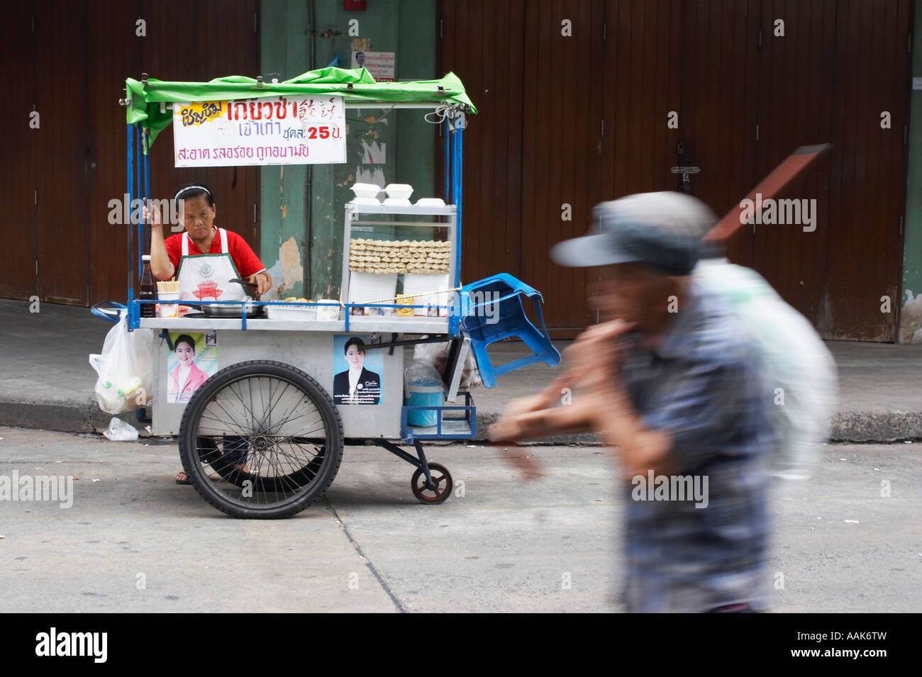 Old Man Walking Past Food Vendor Stock Photo - Alamy