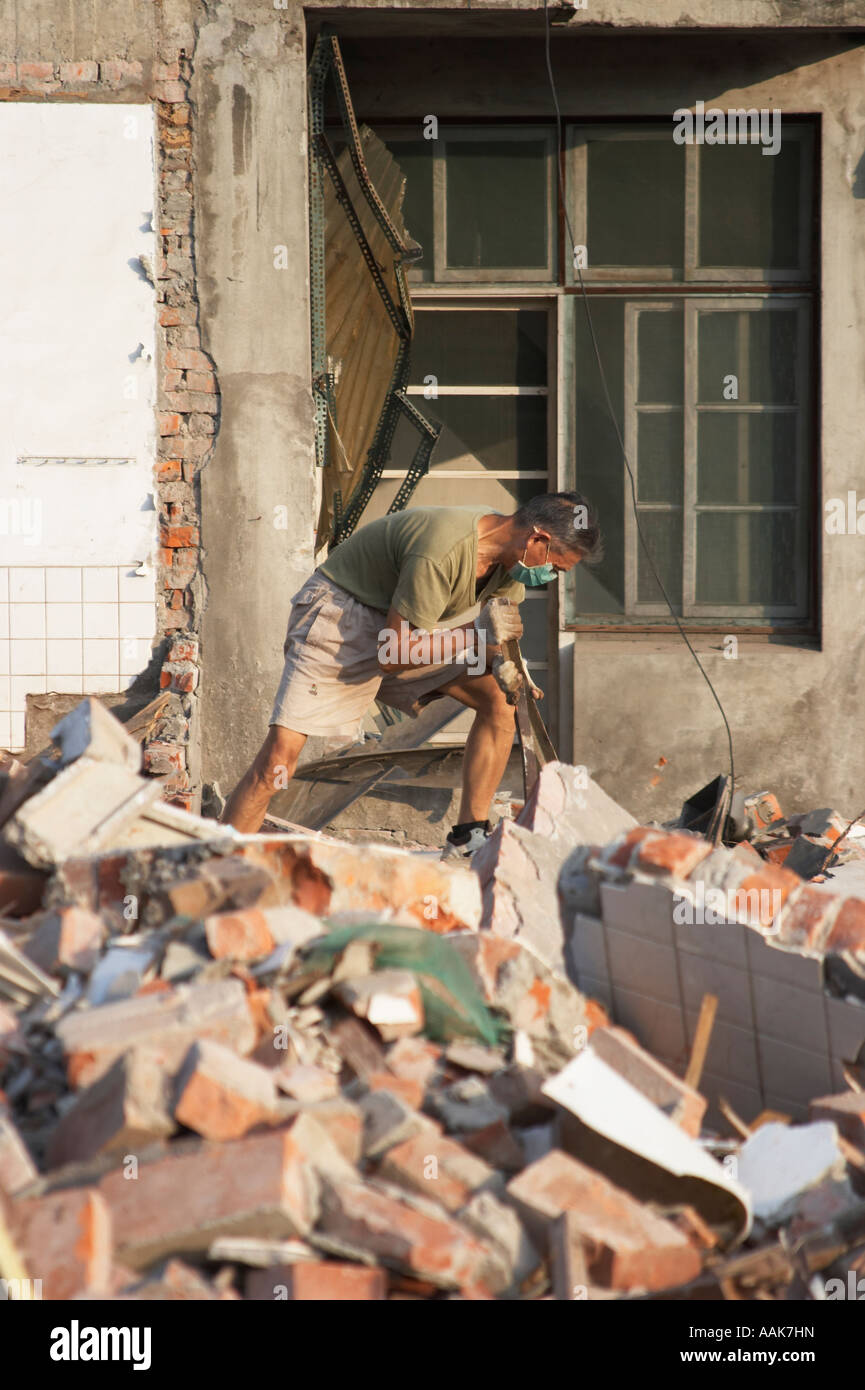 Man Scavenging Through Rubble For Scrap Stock Photo - Alamy
