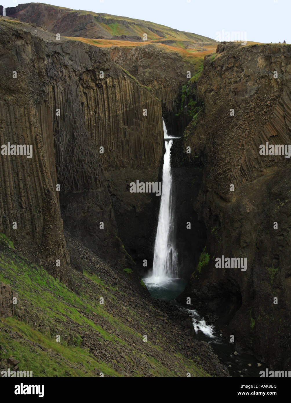 Tall Waterfall with basalt columns in Iceland Stock Photo - Alamy