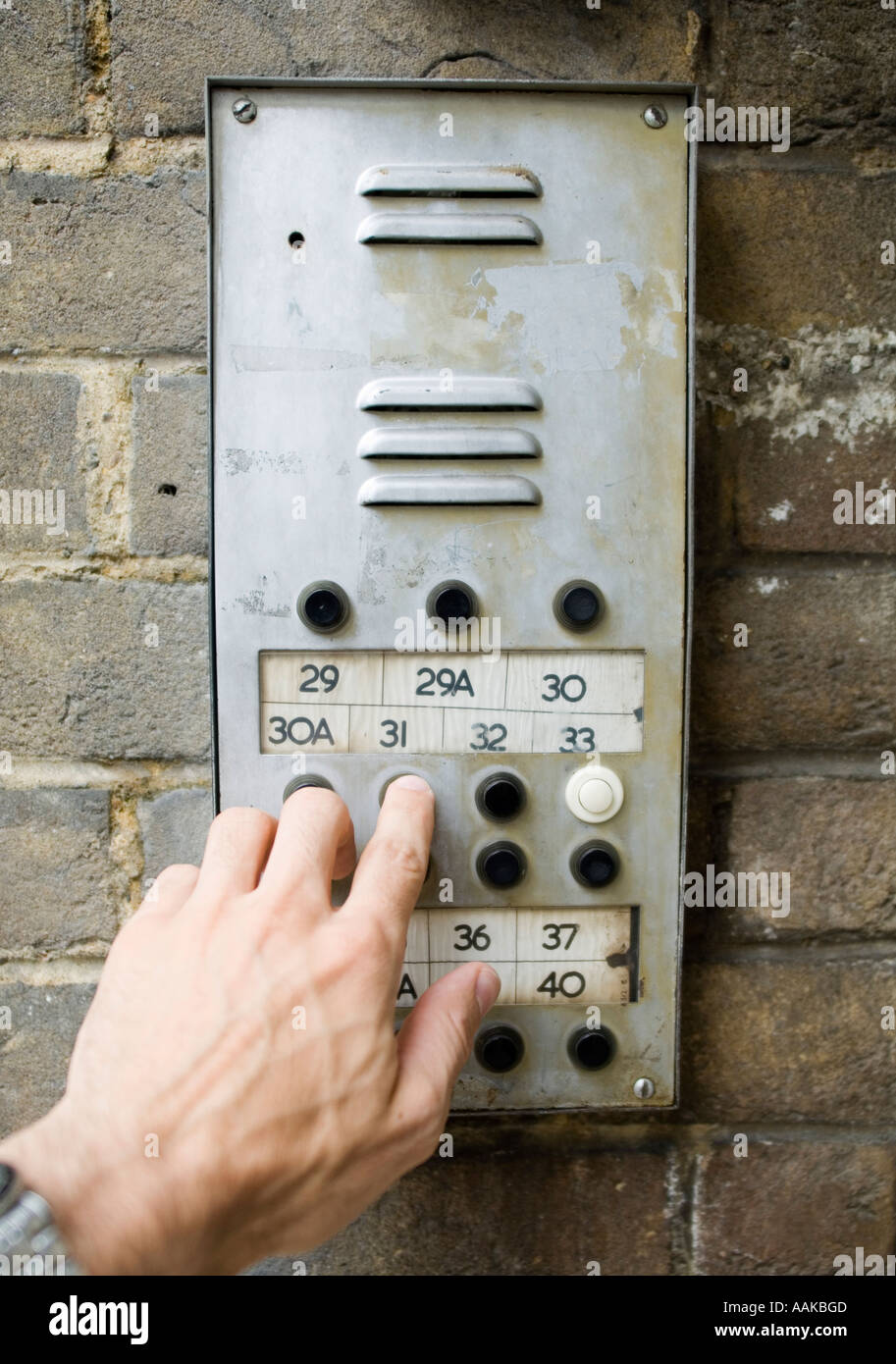 hand pressing buzzer intercom security system 1 0f 2 Stock Photo - Alamy