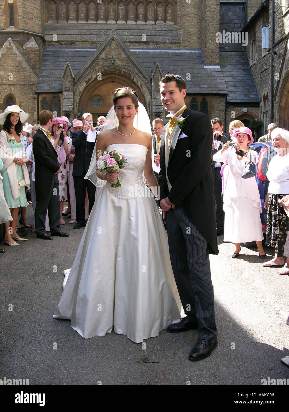 Wedding couple standing outside the church Stock Photo - Alamy