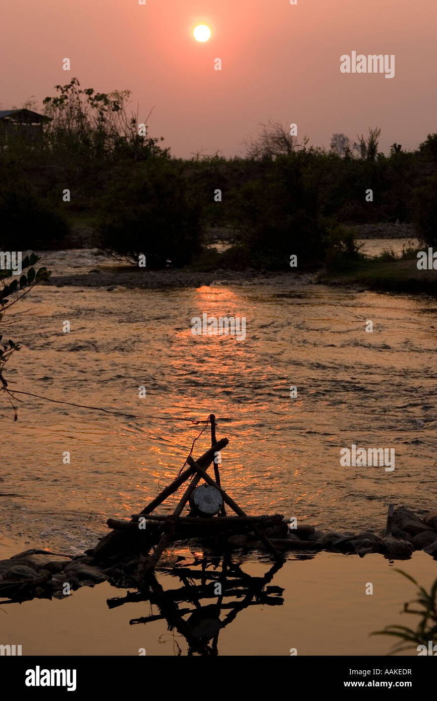 Sunset with small hydroelectric genorator on a river near Muang Long ...