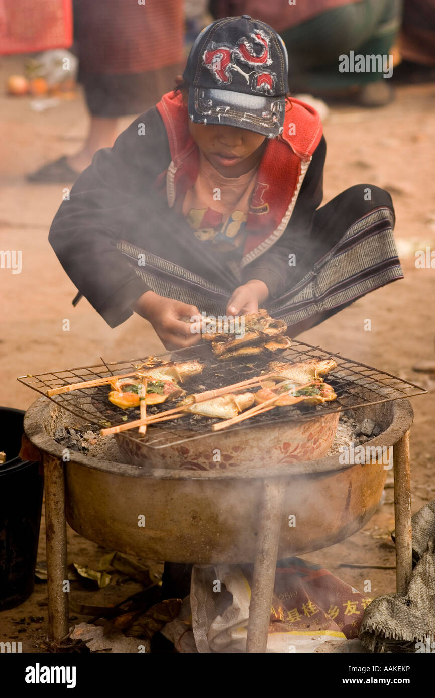 Young girl gilling fish market Muang Sing Laos Stock Photo - Alamy