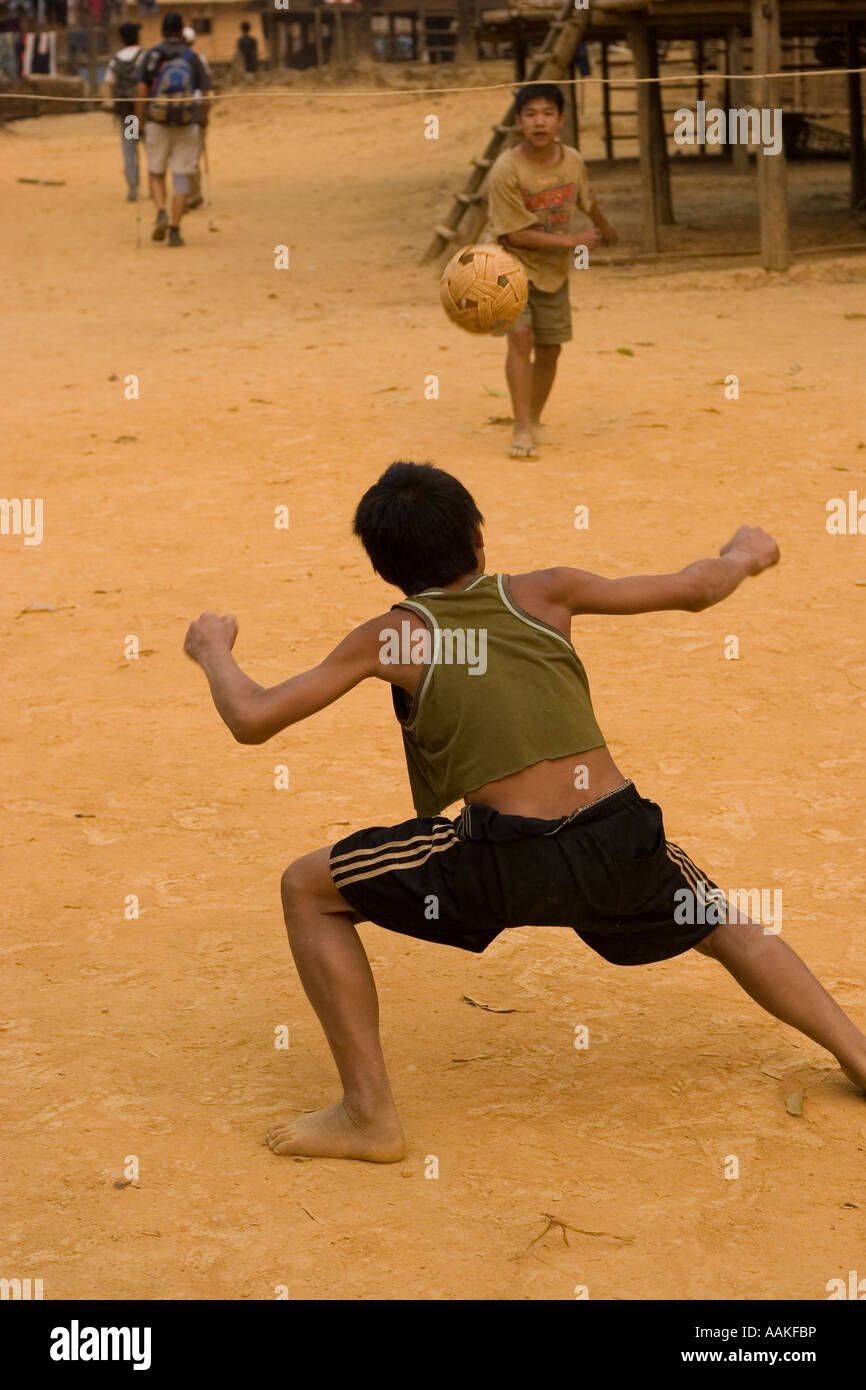 Kids playing ball, sepak takraw, in a village near Muang Ngoi Laos ...