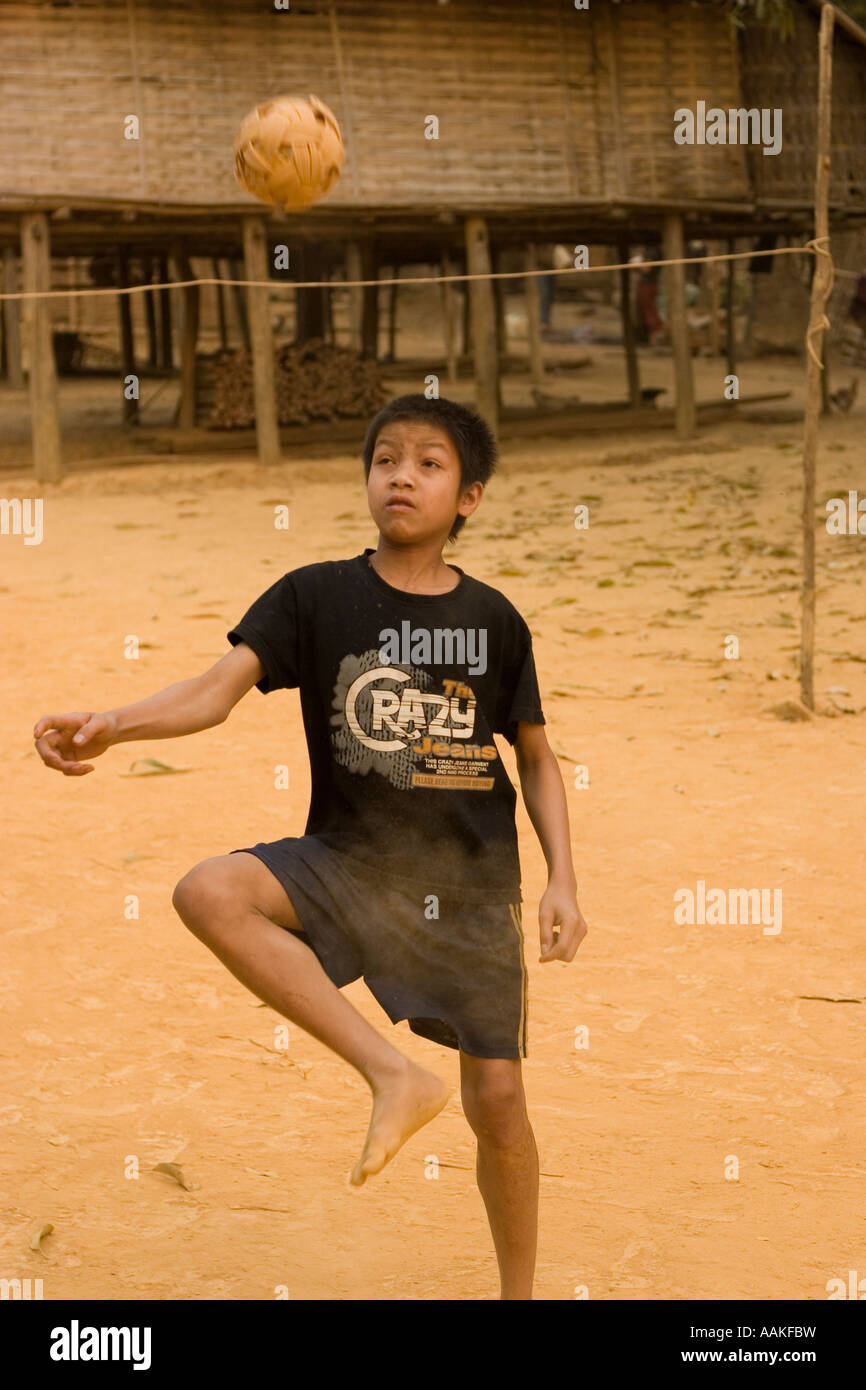 Kids playing ball, sepak takraw, in a village near Muang Ngoi Laos ...