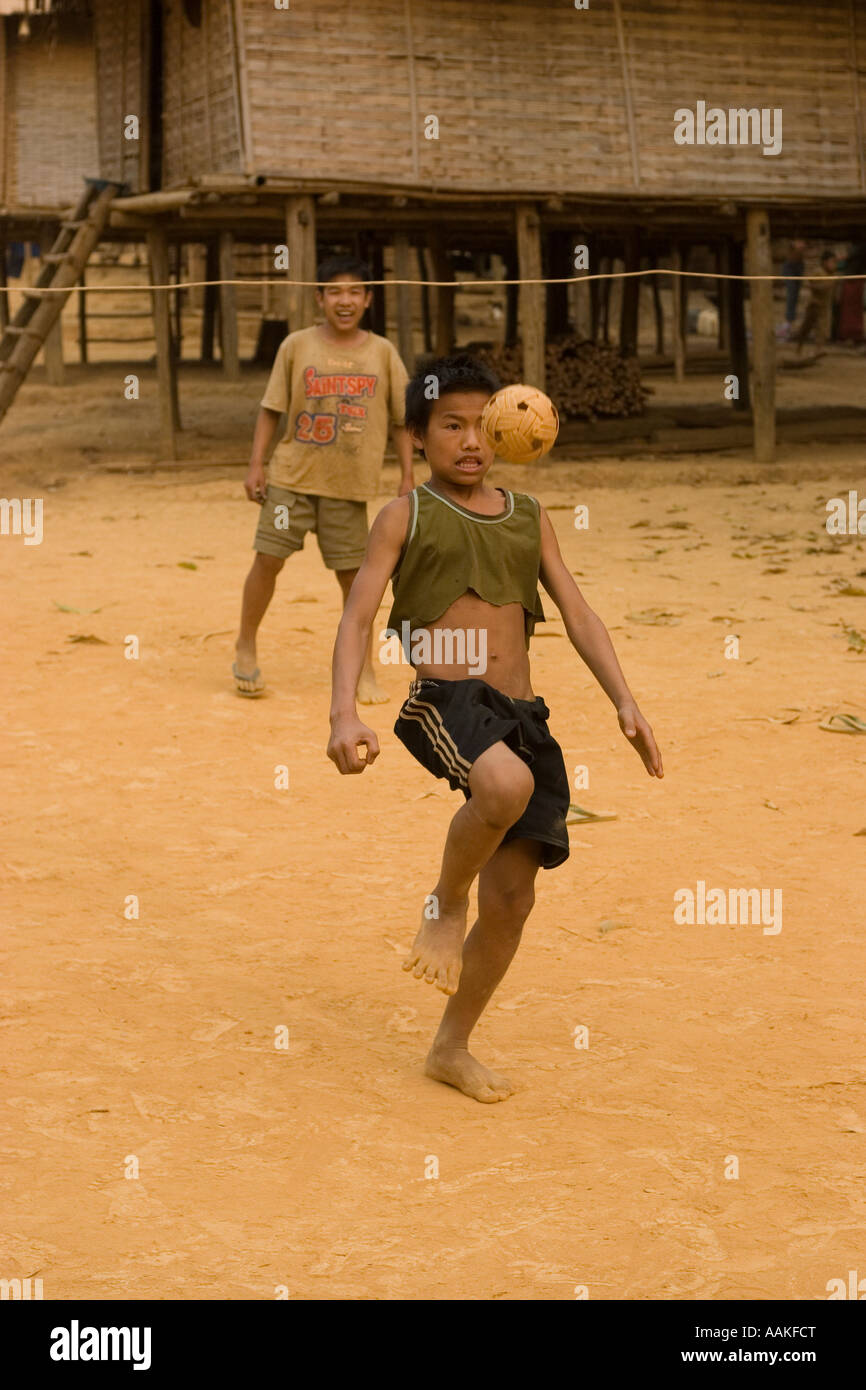 Kids playing ball, sepak takraw, in a village near Muang Ngoi Laos ...