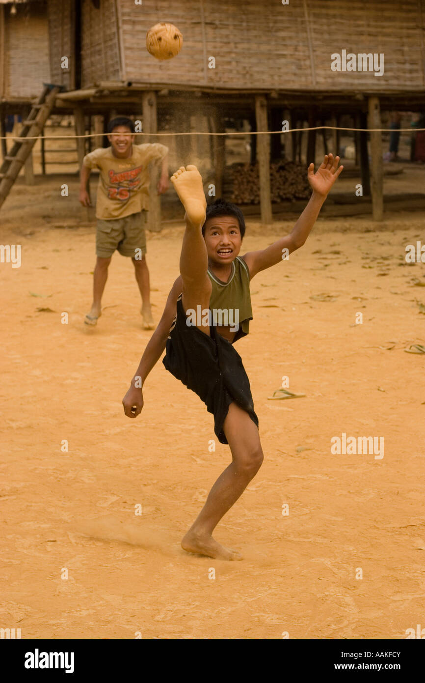 Kids playing ball, sepak takraw, in a village near Muang Ngoi Laos ...