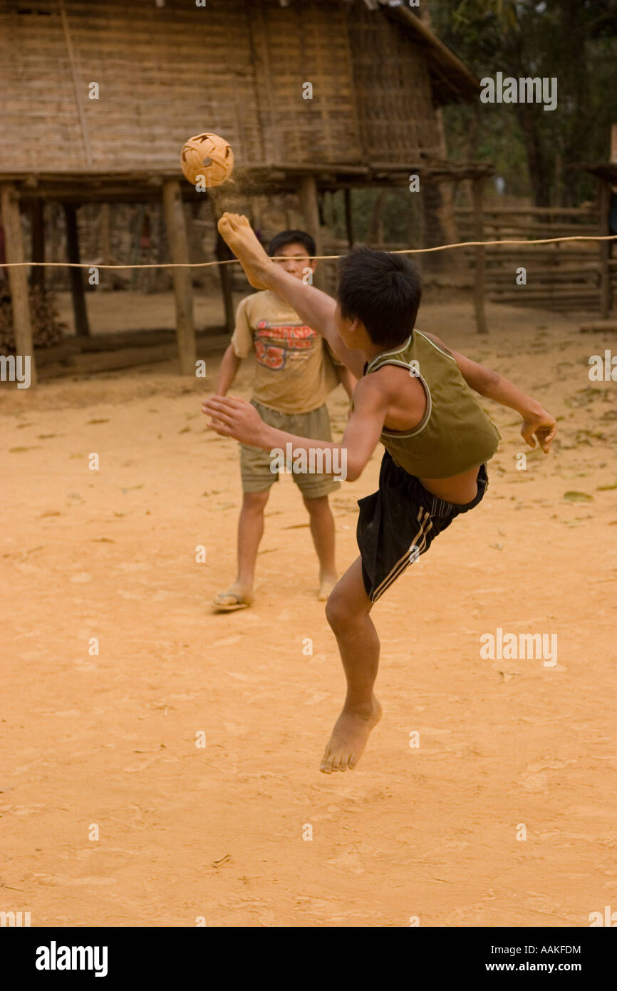 Kids playing ball, sepak takraw, in a village near Muang Ngoi Laos ...