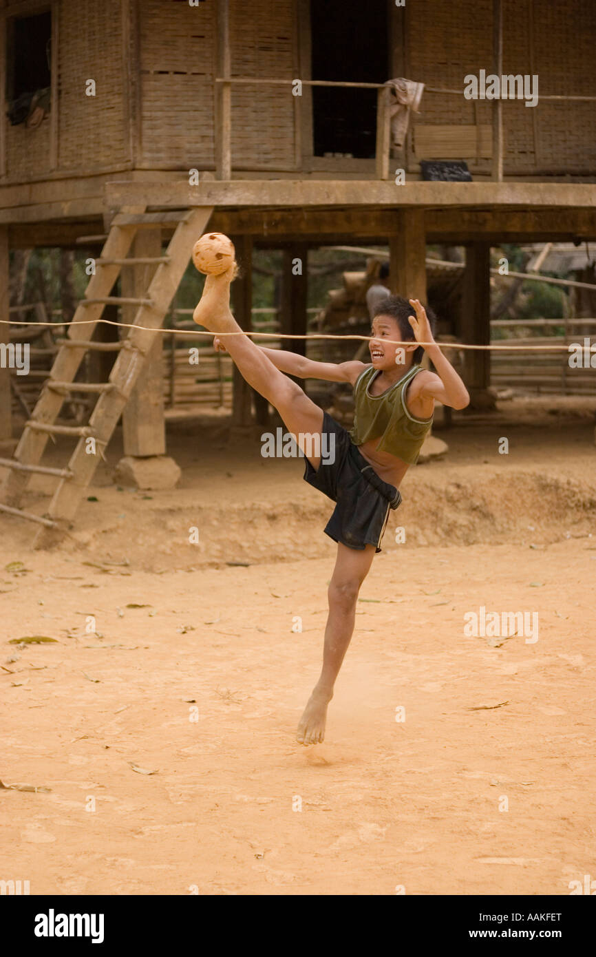 Kids playing ball, sepak takraw, in a village near Muang Ngoi Laos ...