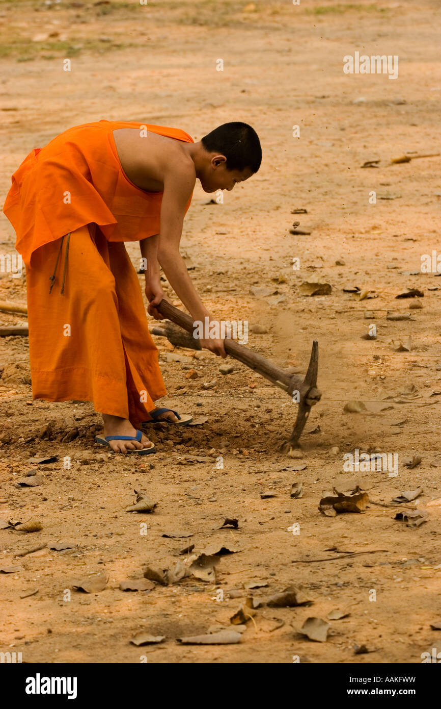 Monks building a pathway at Wat Visoun Luang Prabang Laos Stock Photo ...