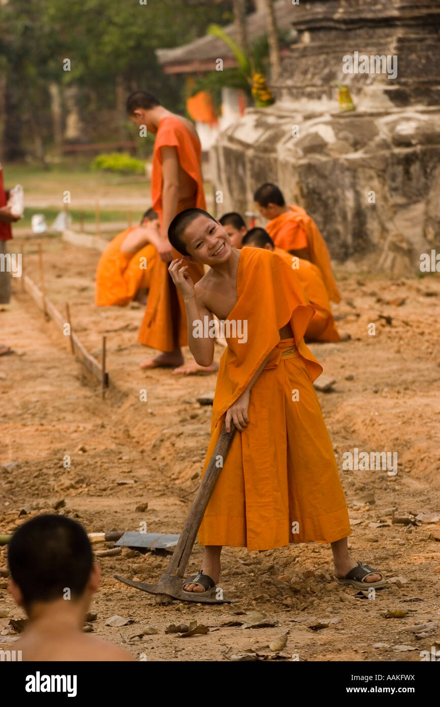 Monks building a pathway at Wat Visoun Luang Prabang Laos Stock Photo ...